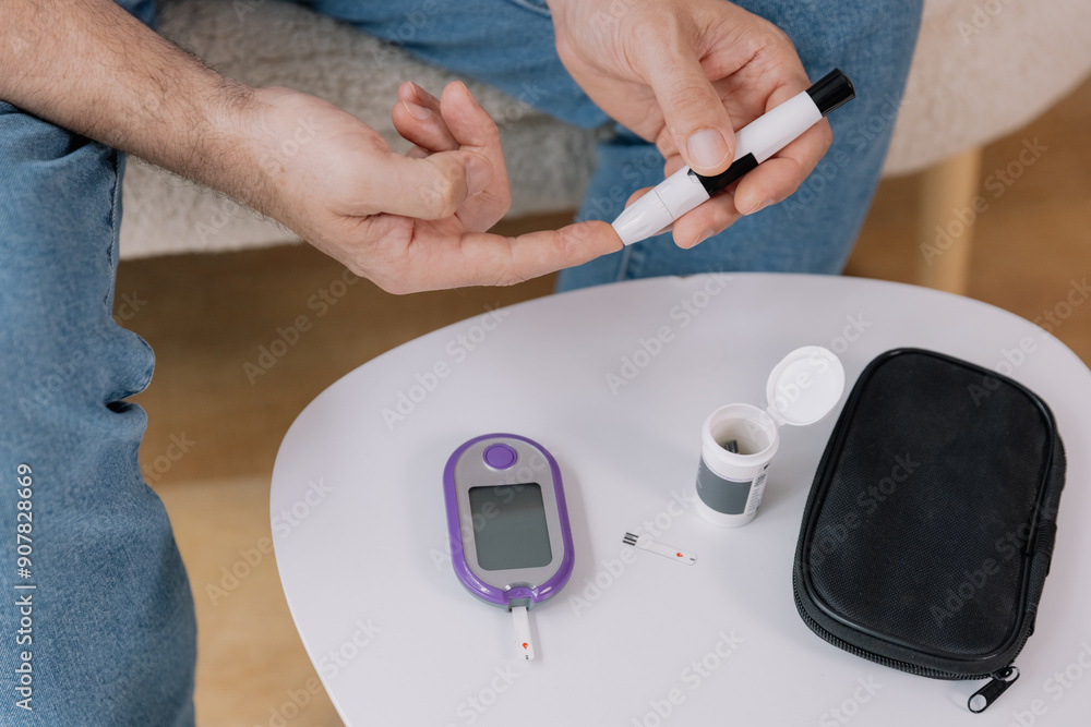 Diabetic senior man on wheelchair checking blood sugar level with ...