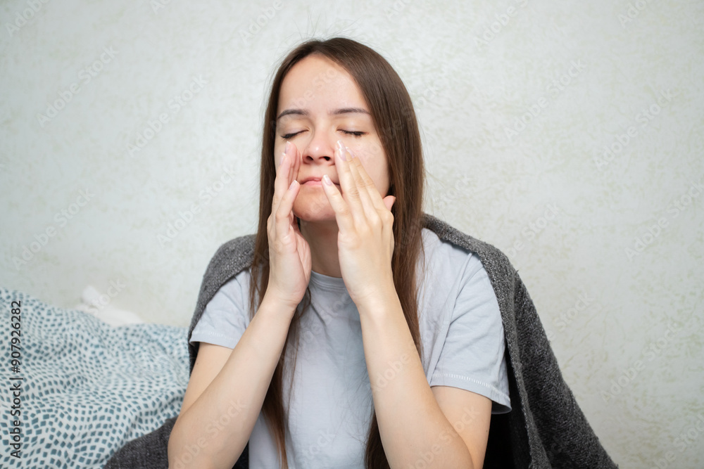 Sick teenager with cold and flu, experiencing nasal congestion, taking ...