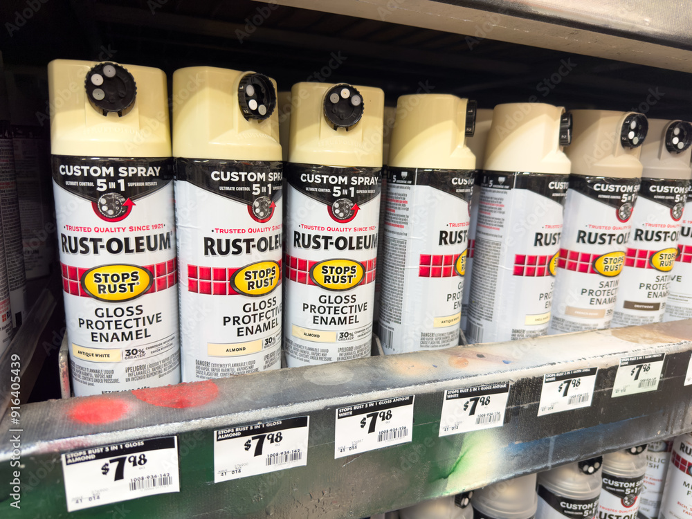 Cans of Rust-oleum brand spray paint on a shelf. Stock Photo | Adobe Stock