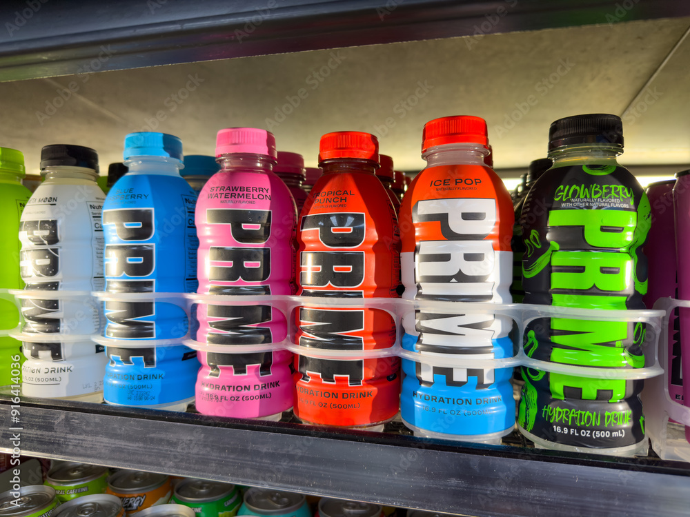 Bottles of Prime hydration drinks in many flavors on display inside a ...