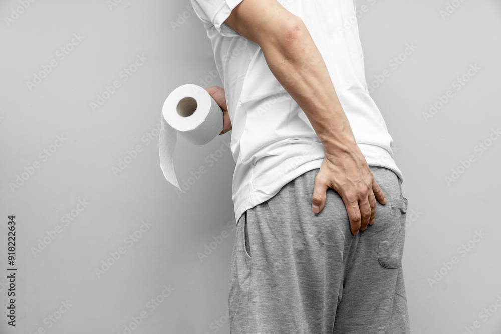 Man with toilet paper suffering from hemorrhoid in rest room, man has ...