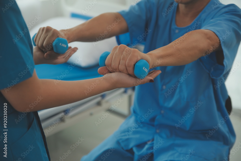 Physiotherapist man giving exercise with dumbbell treatment About Arm ...