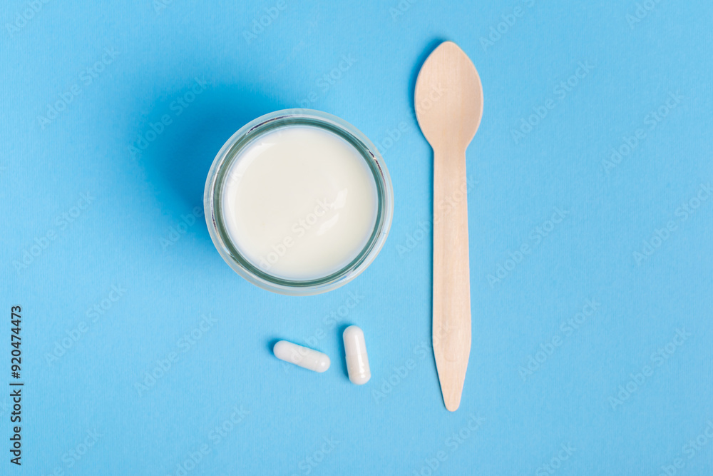 Lactase tablets, yogurt containing lactose and a wooden spoon from ...