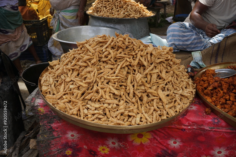 Flour made fried salted snacks called Nimki are on sale in a market ...