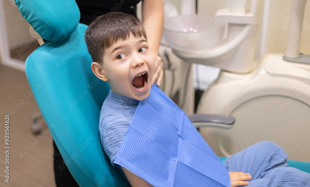 kid in dental office. dentist checking child teeth using tools mouth ...