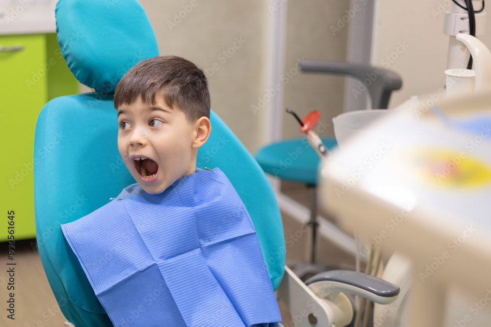 kid in dental office. dentist checking child teeth using tools mouth ...