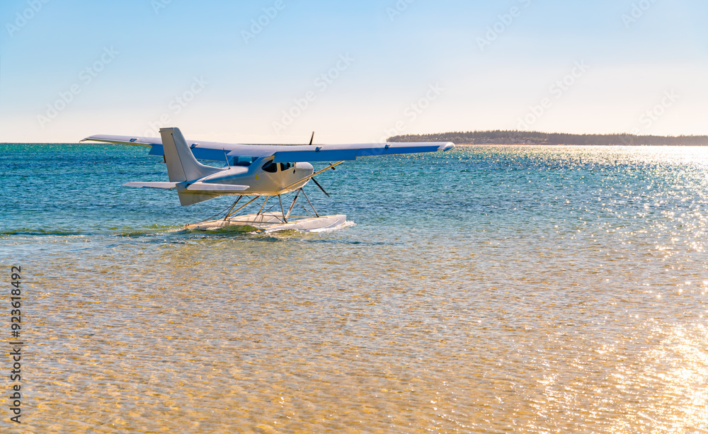 Small white seaplane with skids waiting for a sightseeing flight over ...