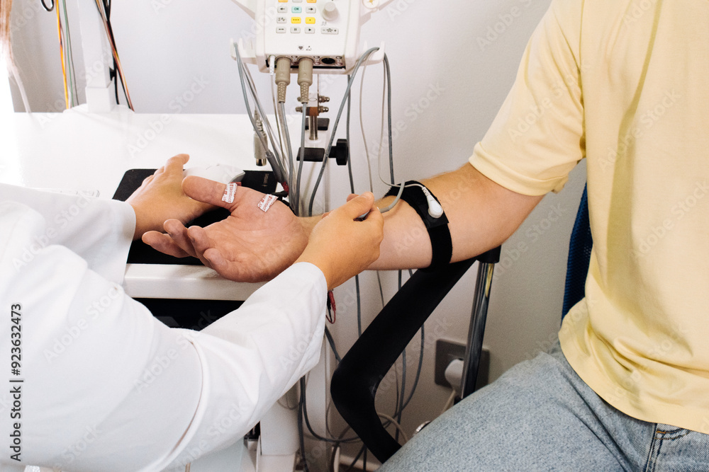 A patient undergoes nerve testing using electromyography (EMG). Perfect ...
