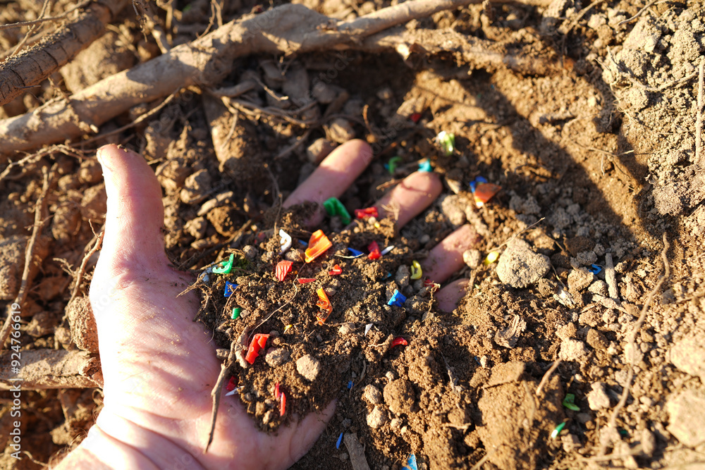 Foto de Stock Microplastic pollution. Microplastics in hand from ground ...