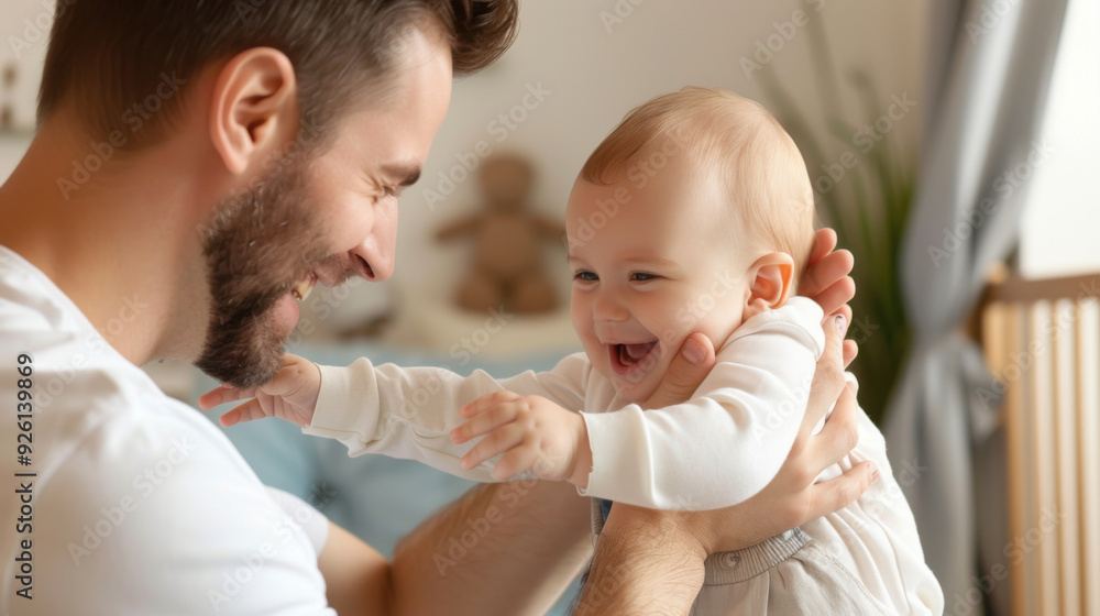 Happy father bonding with his smiling baby, holding them up in a cozy ...