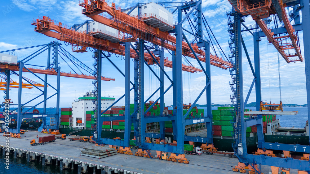 crane loading cargo container from truck to container ship in the ...