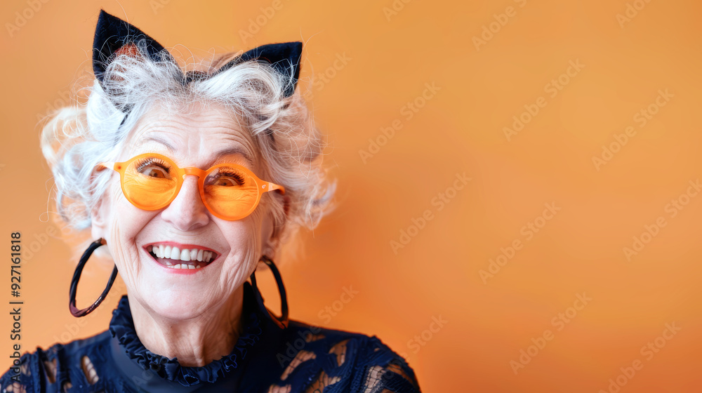 An ecstatic old lady wearing cat ears and orange glasses exudes joy ...