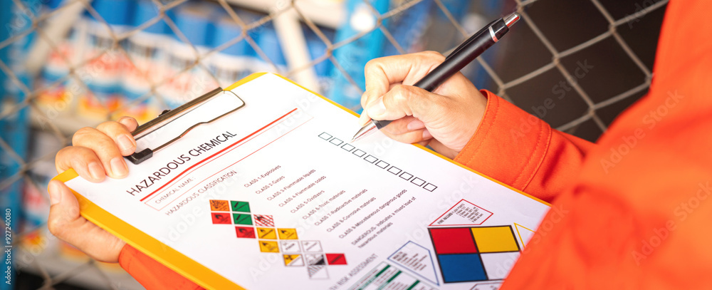Extreme close-up at industrial worker'hand during verify on chemical ...