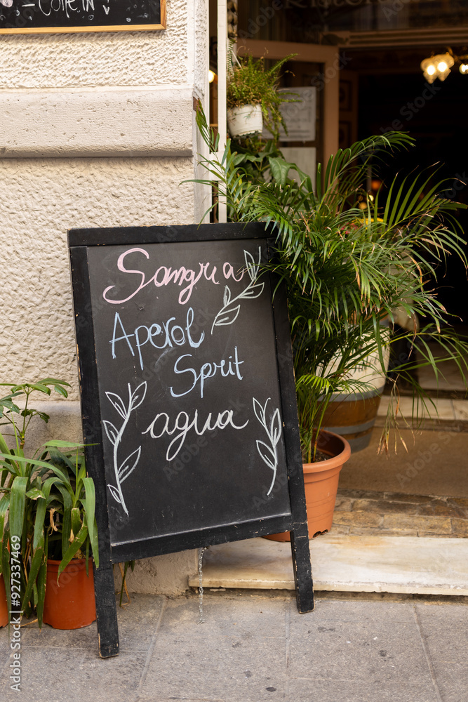 Restaurant sidewalk chalkboard sign board. Old Signboard with pots on ...
