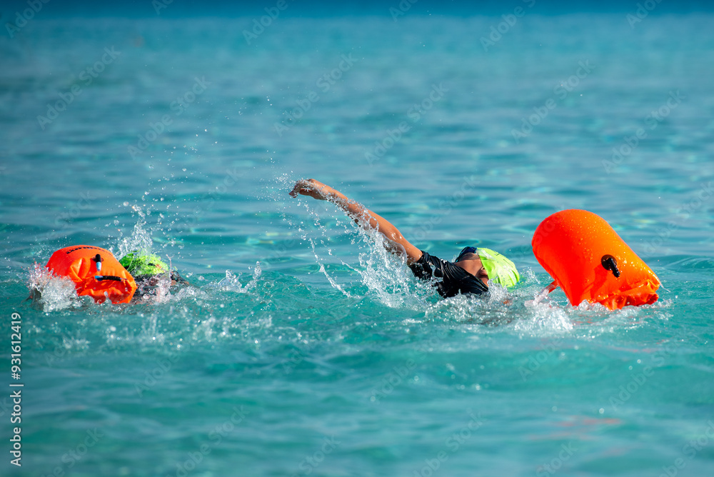 Athletes swimming free style in the sea Racing competition. Swimmer in ...