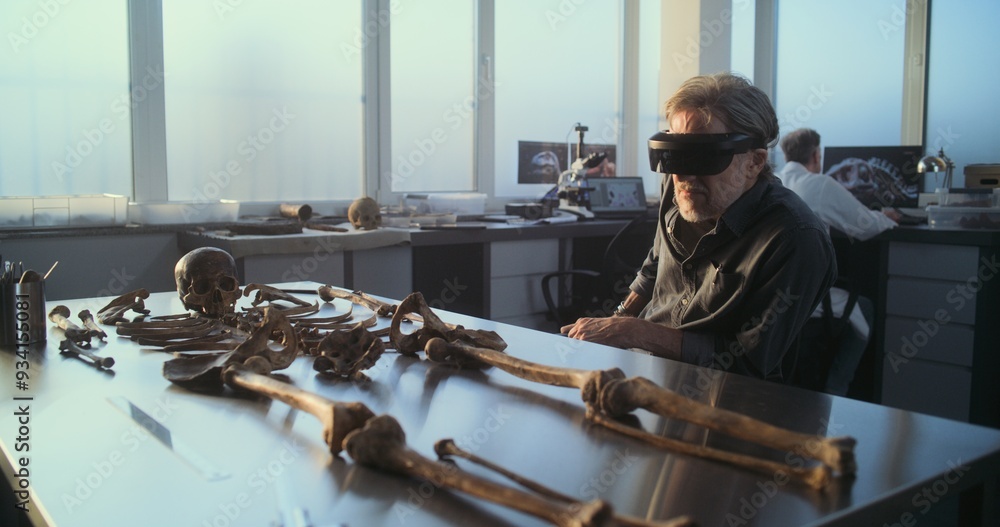 Mature archaeologist in VR headset studies remains of ancient human ...