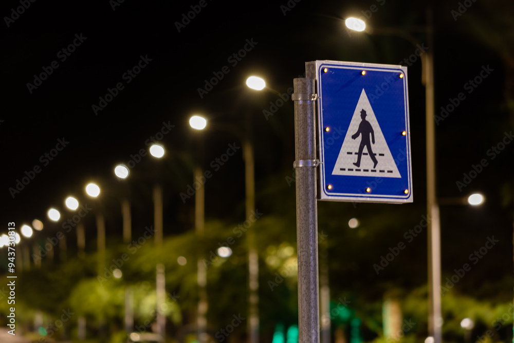 Pedestrian crossing sign at night. Illuminated road sign. City street ...