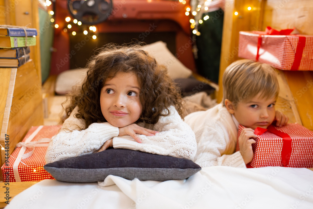 Cute little boy and girl in pickup trailer with lights on background ...