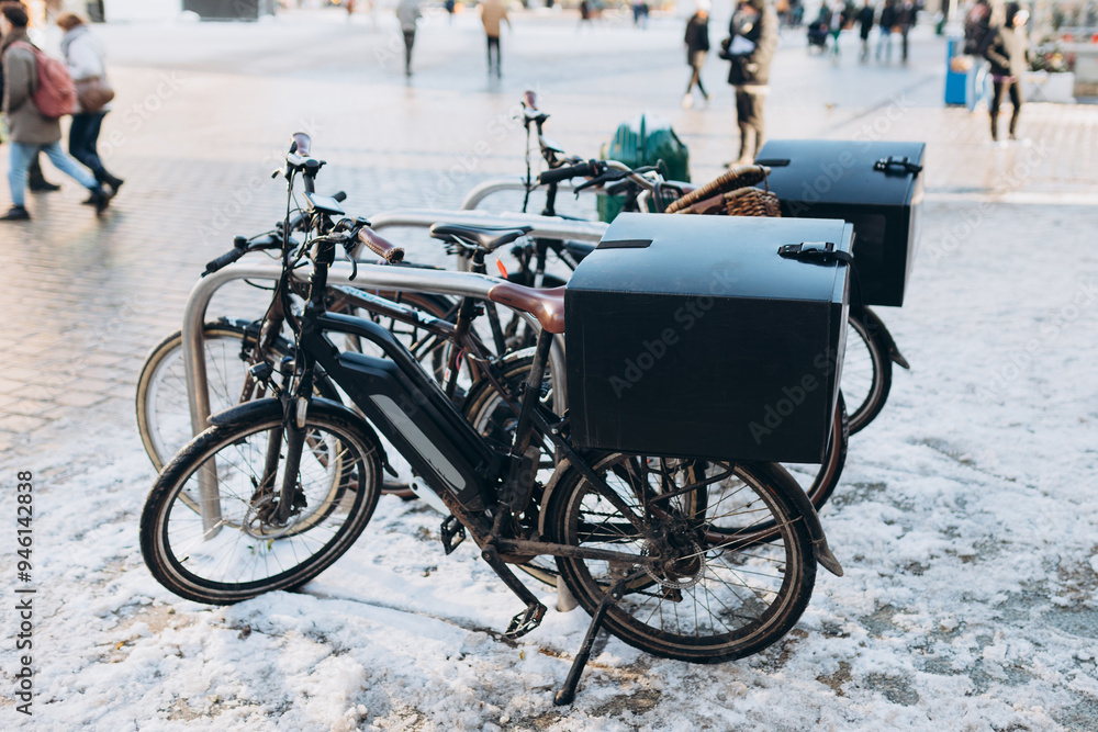 Bicycles parking for food delivery company employees on the street. A ...