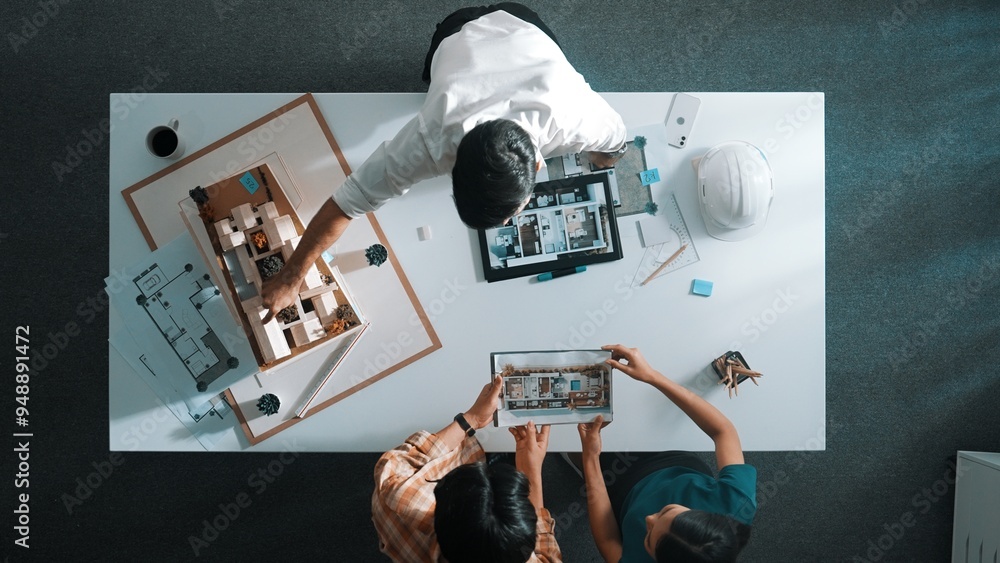Top down view of civil architect looking at project plan while present ...