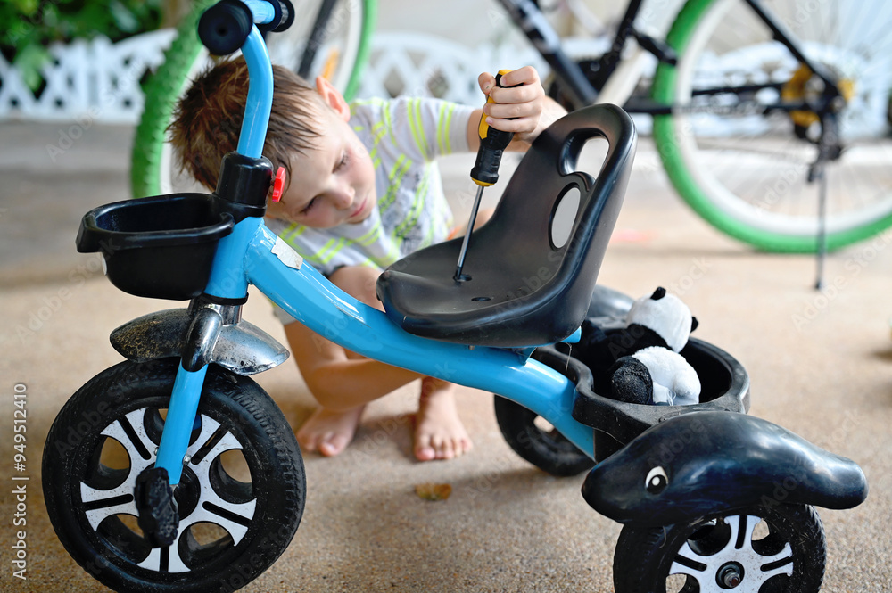 Kid boy repairing bicycle Stock Photo | Adobe Stock