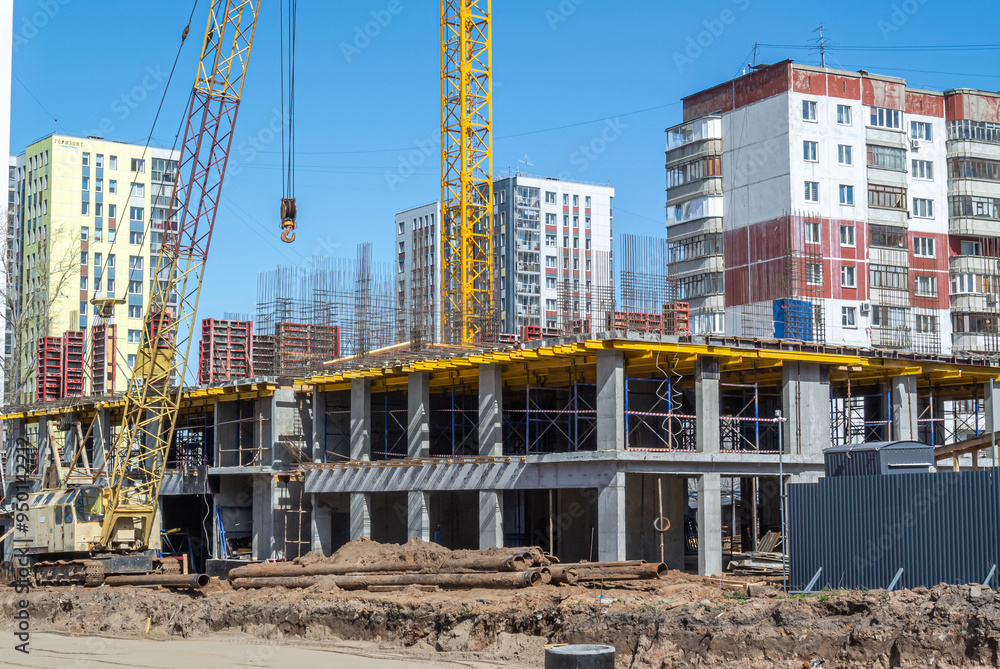 A construction site where tower and crawler cranes perform lifting work ...