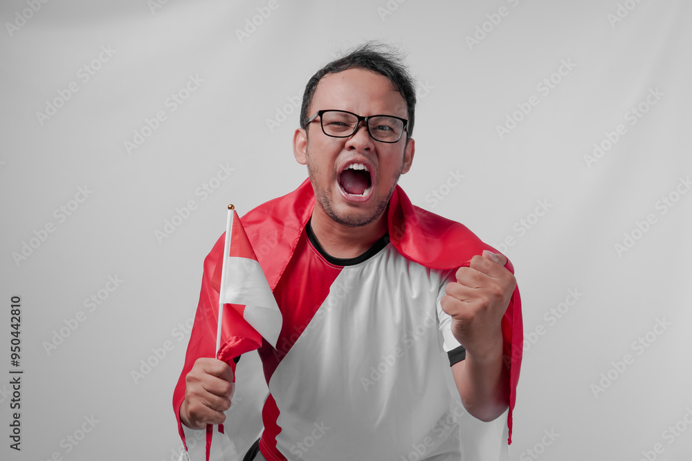 Funny looking Indonesian man holding their country flag while raising ...