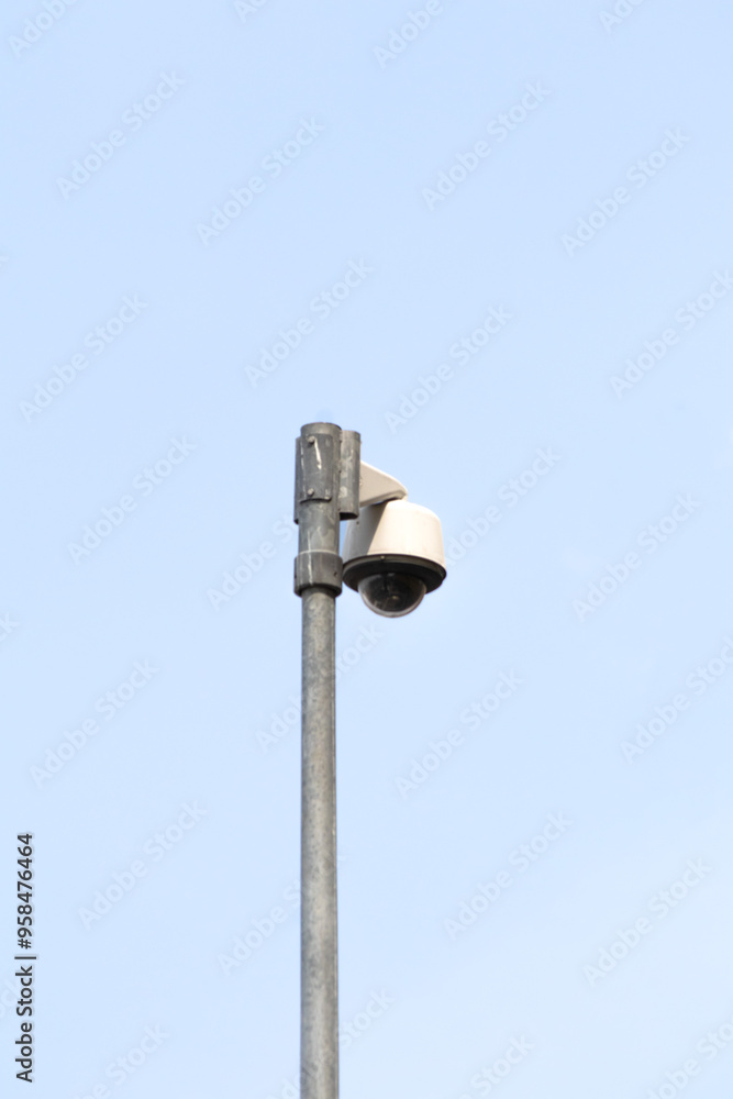 Security camera on pole in blue sky background. CCTV equipment at ...