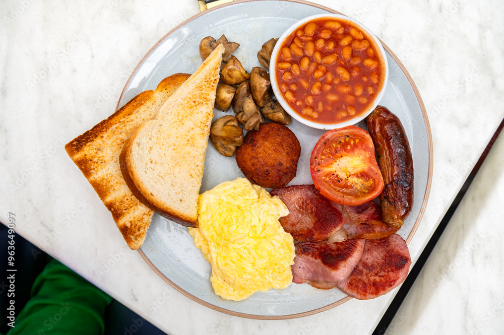 Full English Breakfast with sausage, mushrooms, tomato, bacon, homemade hash brown, baked beans ...