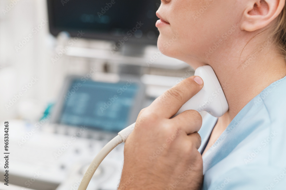 woman receiving thyroid diagnostics doctor's hand with sensor in rubber ...