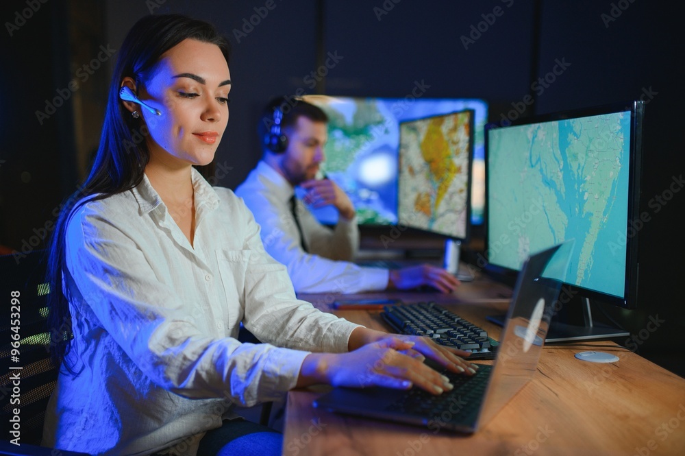 Center of dispatching maintenance. Portrait of cheerful woman and man working via headset ...