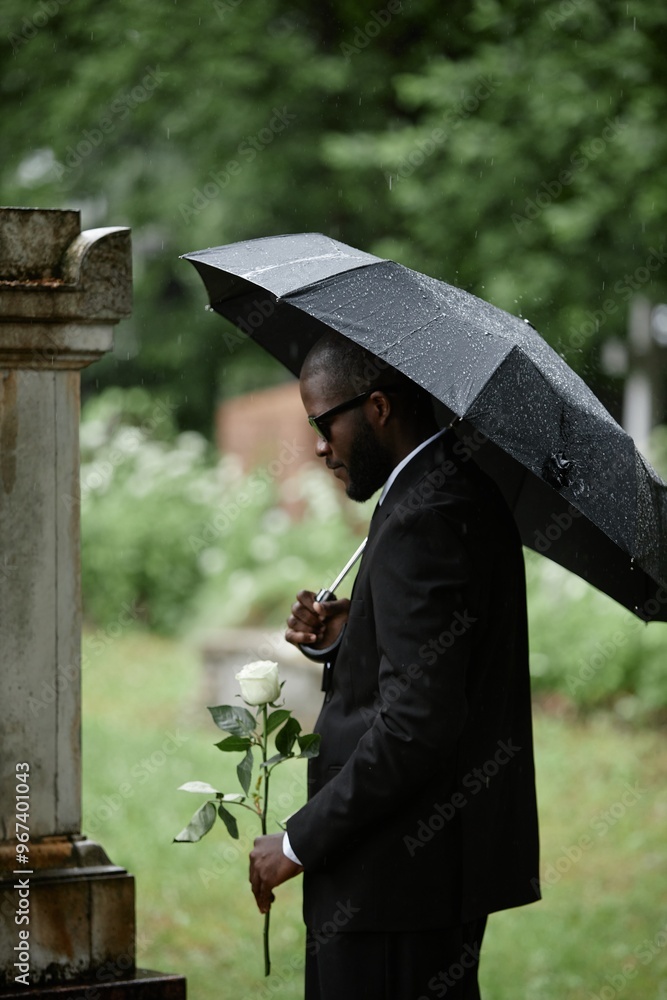 Foto de Stock Vertical shot of Black man grieving over loss of relative ...