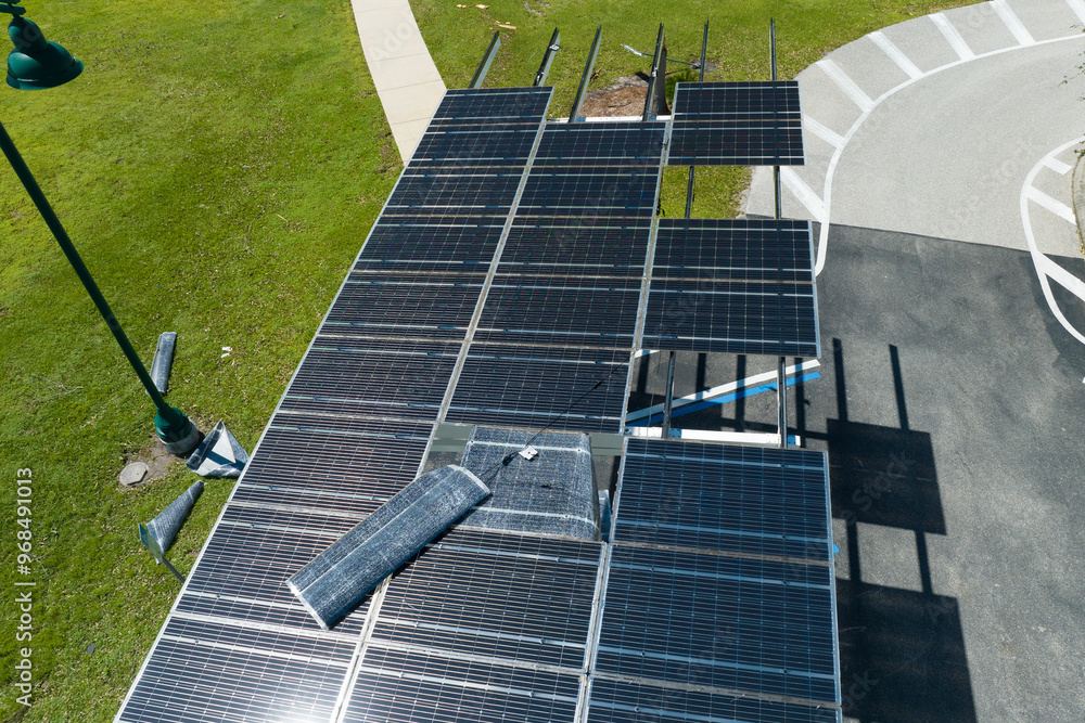 Damaged by hurricane wind photovoltaic solar panels mounted on parking ...