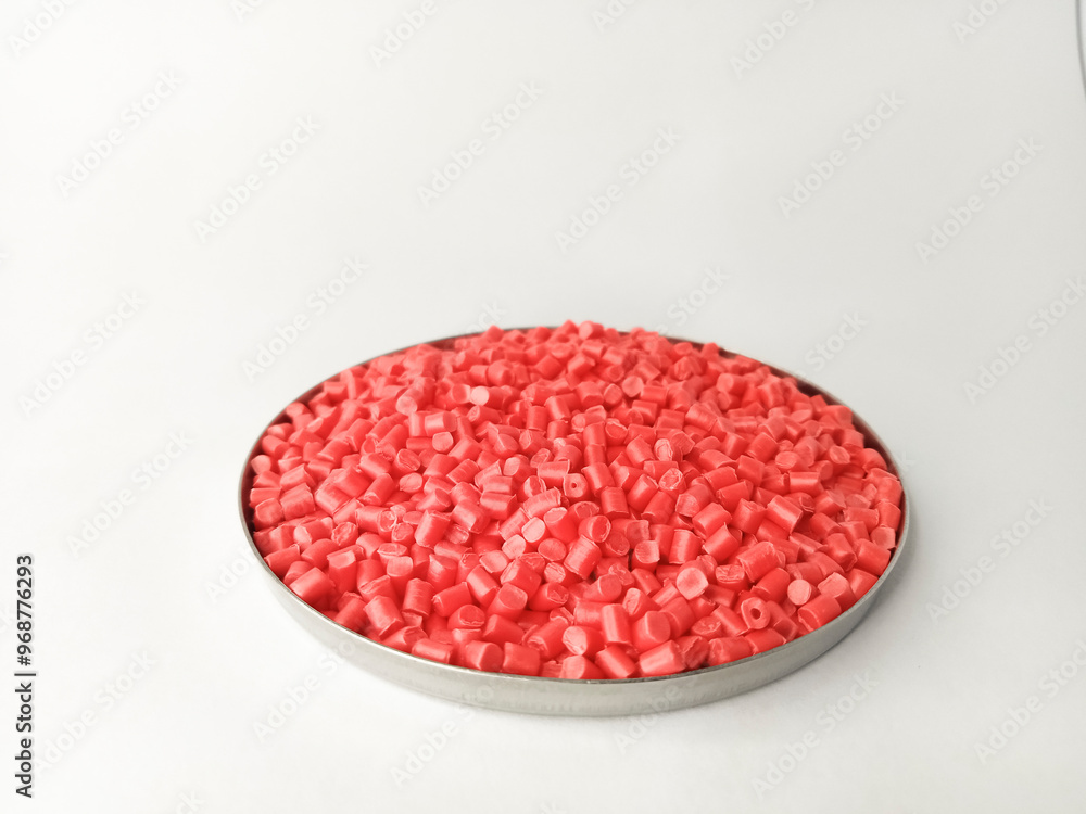 Red masterbatch granule, red pigment, red polymer granules in a cup ...