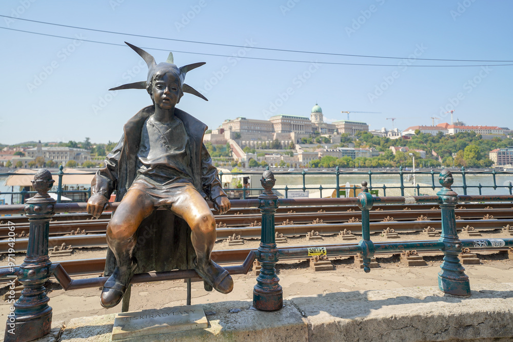 budapest, hungary, 05 08 2024 : bronze sculpture of little boy sitting ...