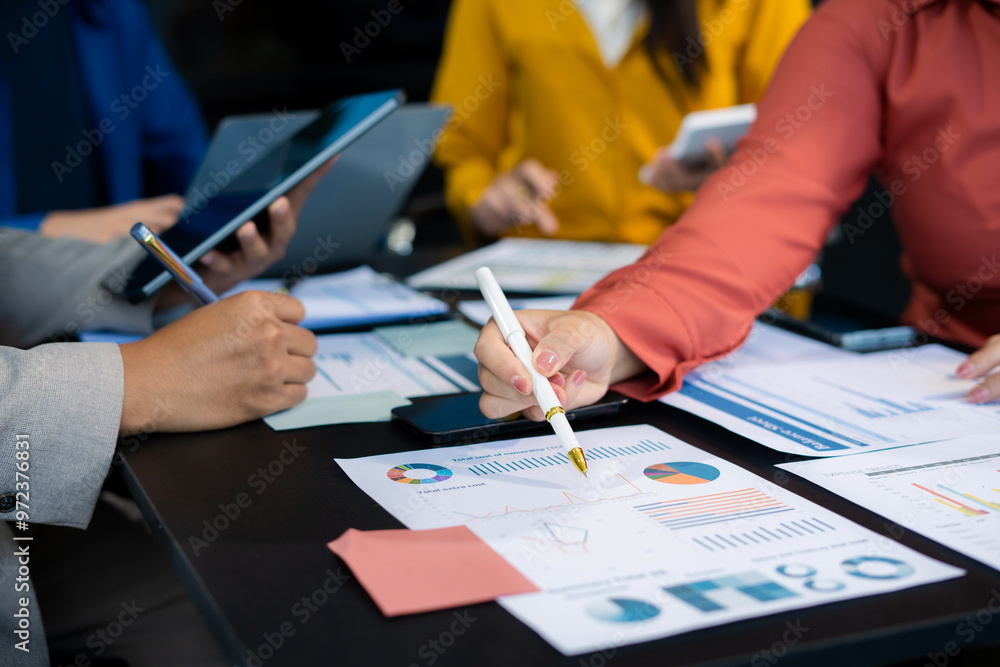 Business team using a calculator to calculate the numbers of statistic ...