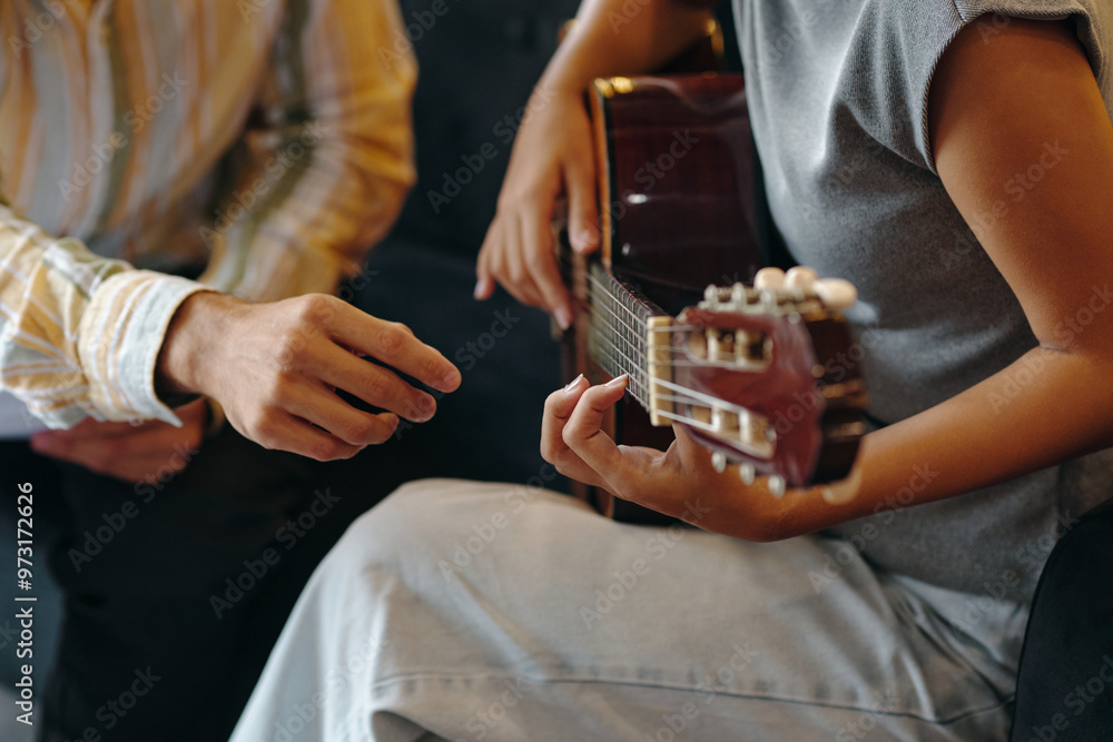 Stock-Foto „Hands of person strumming guitar strings during music ...