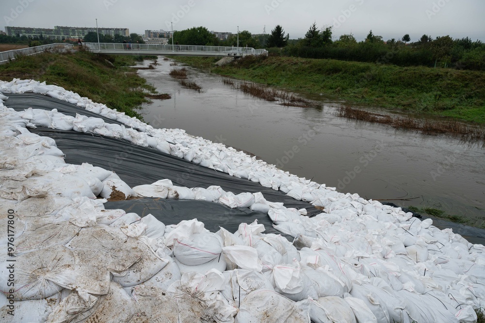 Reinforcement of river embankments with foil and sandbags, flood risk ...