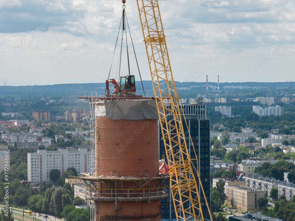Aerial drone view of demolition of chimney, excavator working on ...