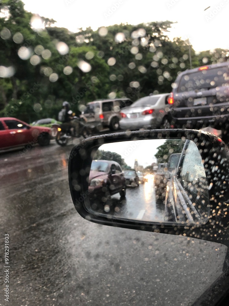 Traffic in rainy day with road view through car window with rain drops ...