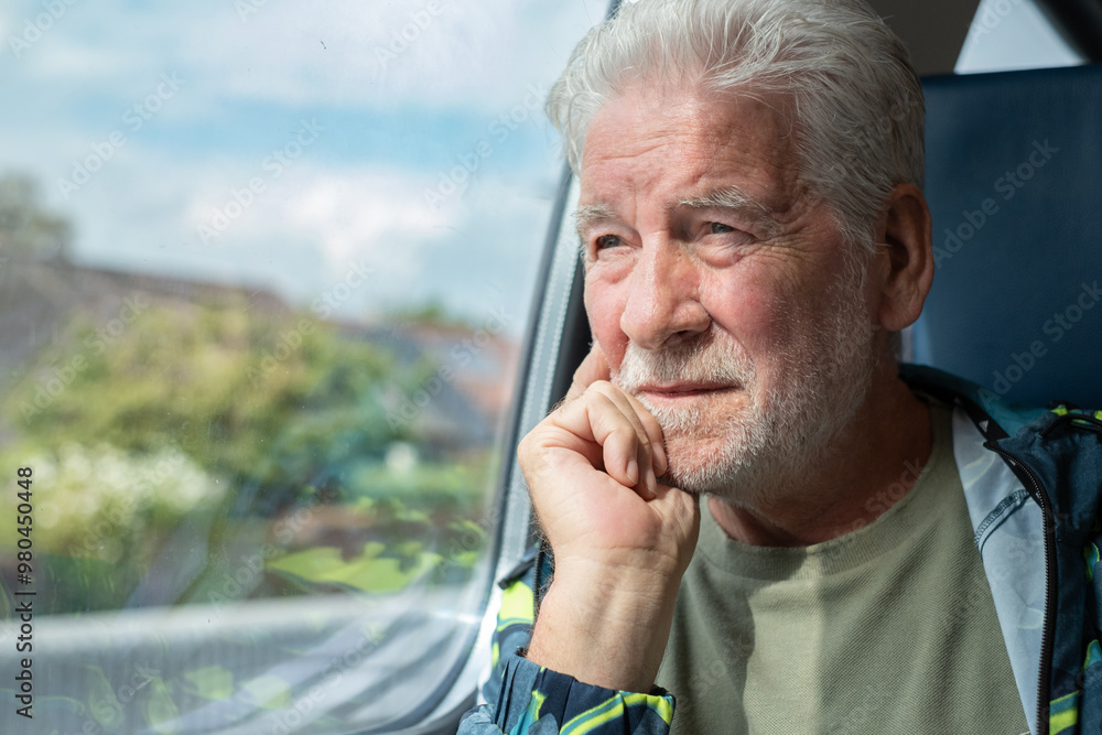 Serious bearded old senior man sitting on train, savoring time spent on ...