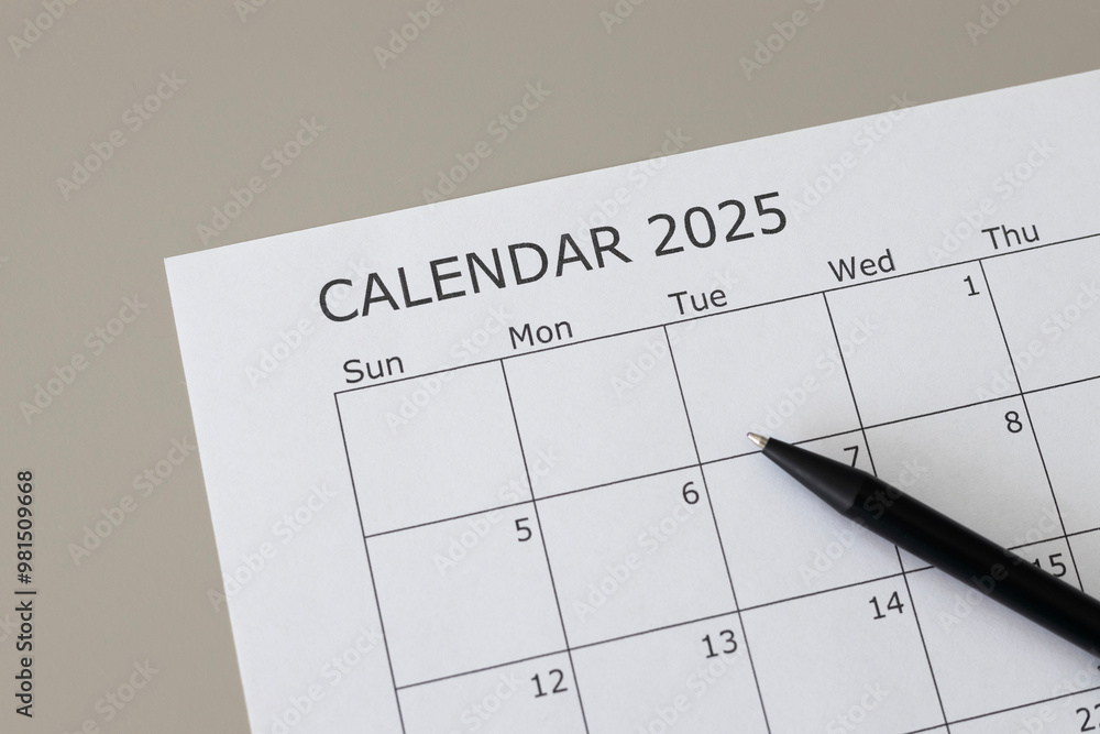 2025 calendar close up. Blank calendar with 2025 writing and a pen ...