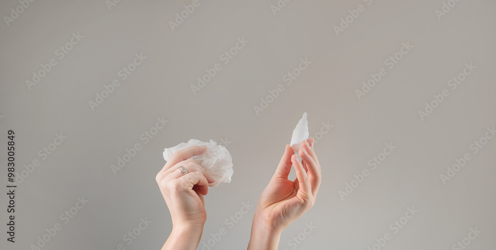 Nasal hygiene with spray, girl clears nasal passages by blowing into a ...