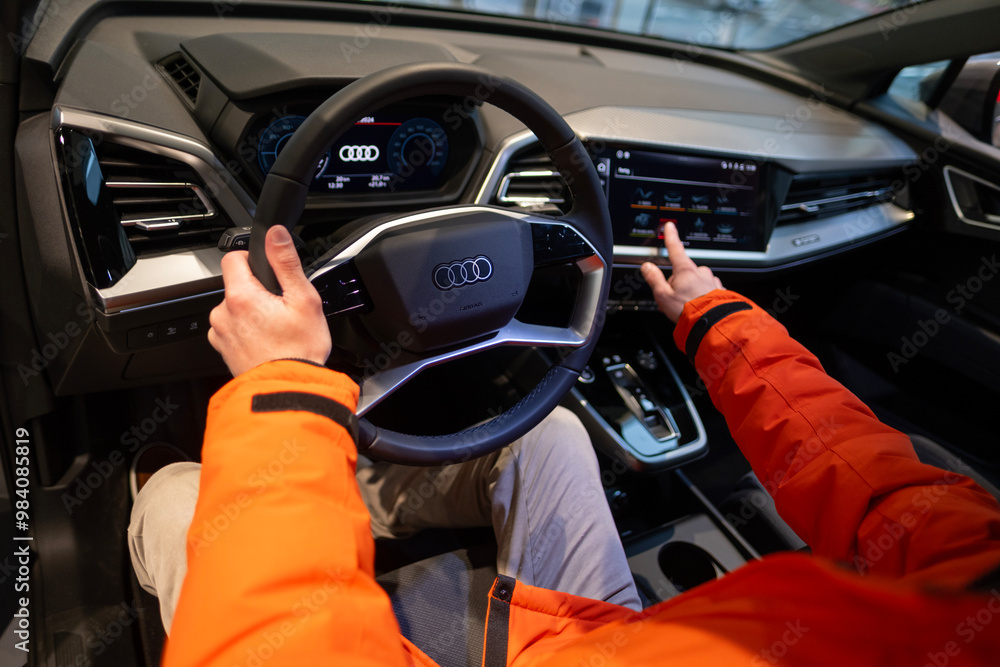 close-up man in car driving electric crossover Audi Q4 e-tron, German ...