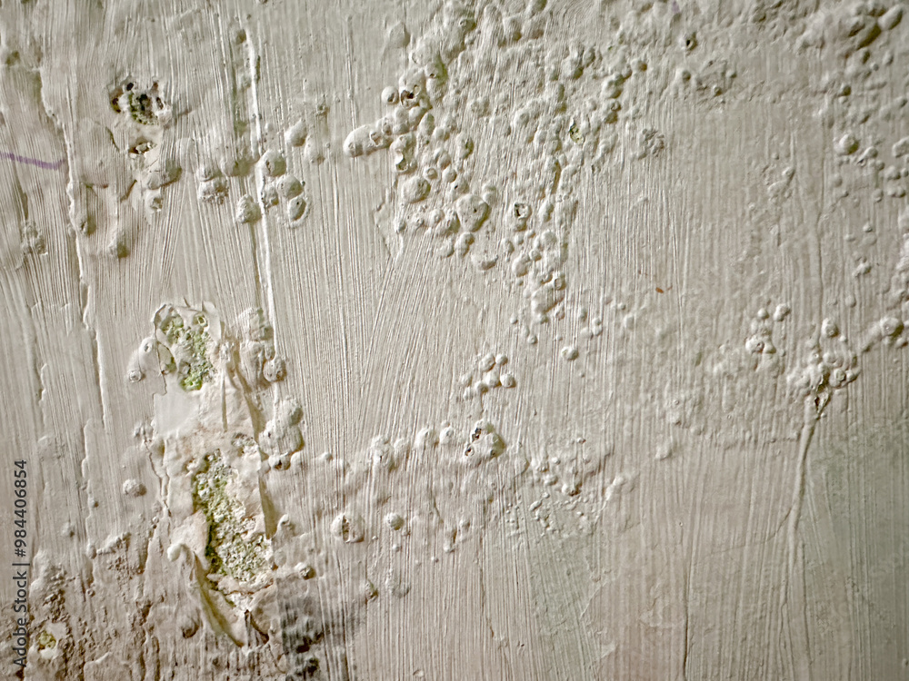 close up view of wall with bubbling paint and cracks, revealing damp ...
