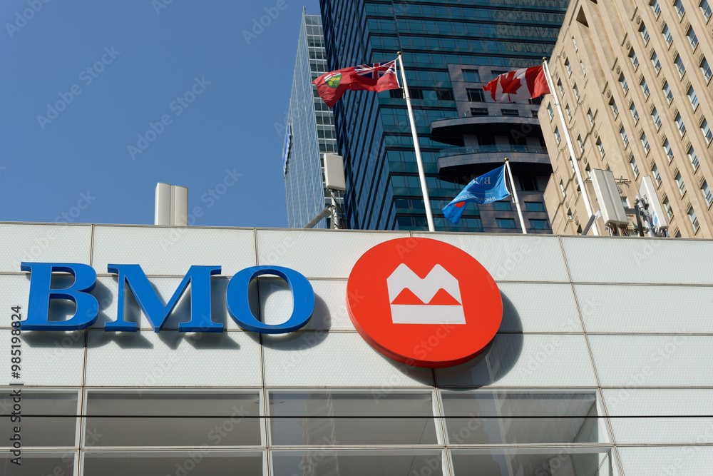 BMO Bank of Montreal logo sign with flags above at the northwest corner ...