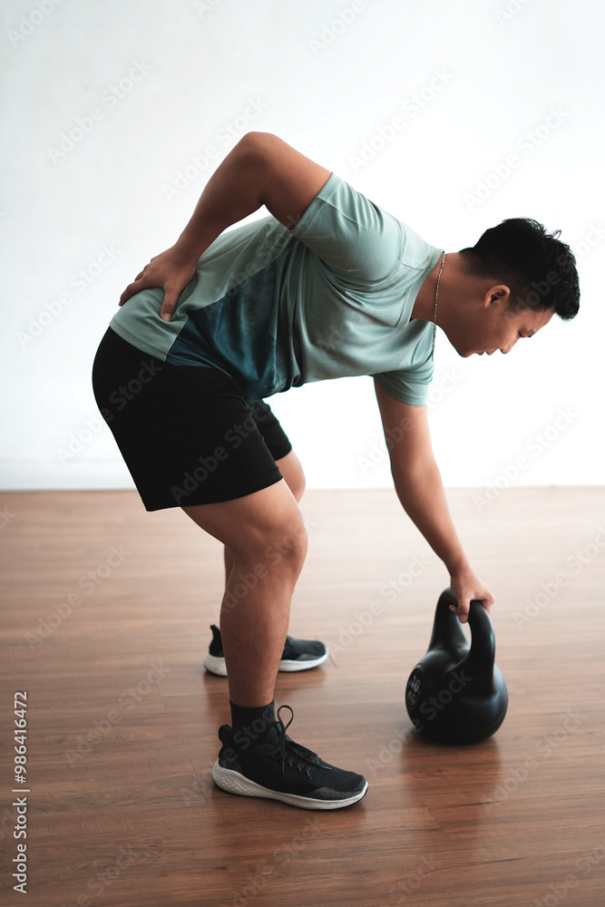 Sport man feeling lower back pain or spine pain after doing weight ...