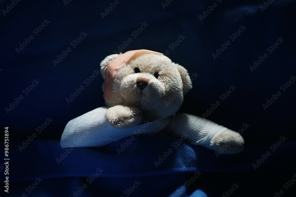 Injured sick teddy bear bandaged with bandage and plaster. Trauma that ...
