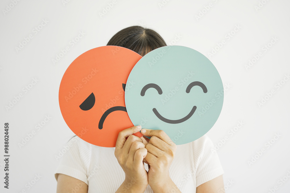 Woman hands holding sad face hiding behind happy face, bipolar and ...