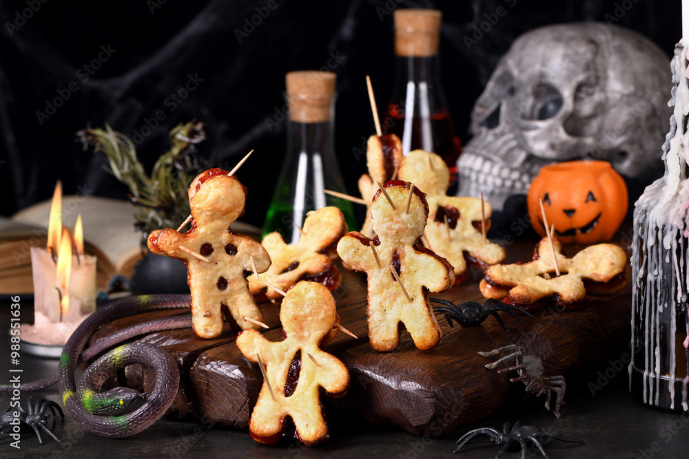 Voodoo cookies made of puff pastry with jam and pierced with wooden ...